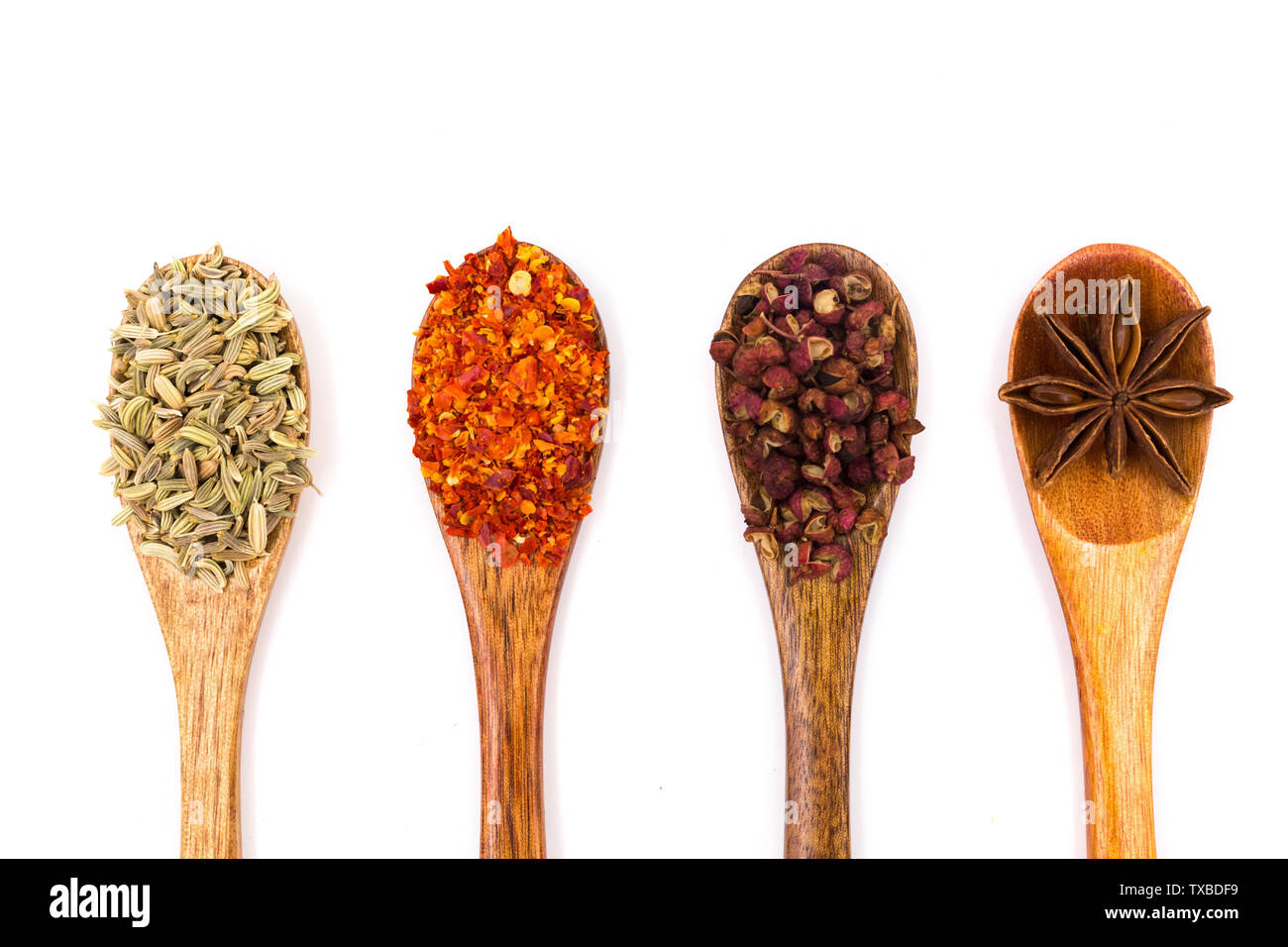 Multiple wooden spoons filled with various seasonings Stock Photo - Alamy