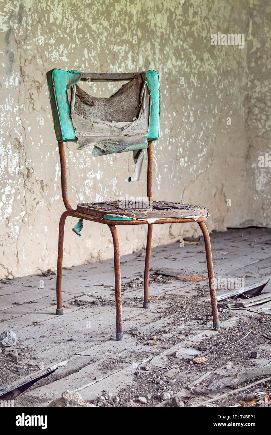 Shabby,vintage abandoned chair in a room with broken floorboards and ...