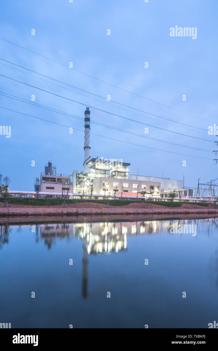modern power station near river at twilight Stock Photo - Alamy