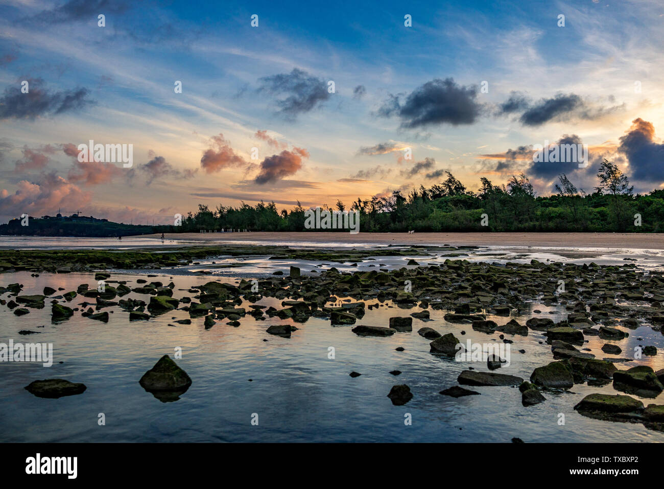 Beach / reef, early sunset Stock Photo - Alamy