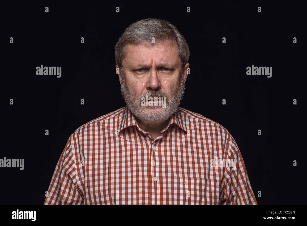 Close up portrait of senior man isolated on black studio background ...