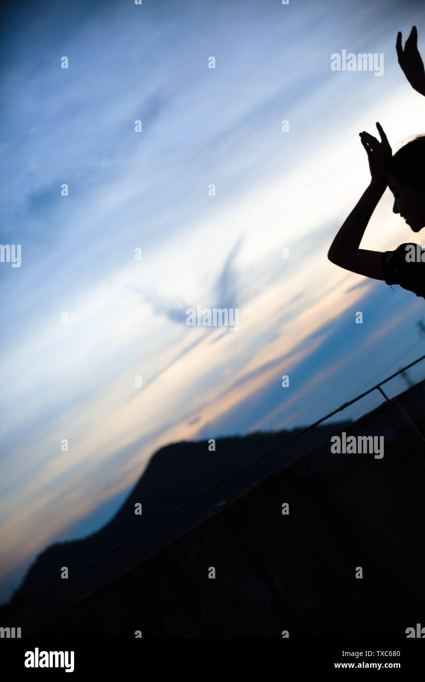 Cloud rooftop sky dusk girl girl Stock Photo - Alamy