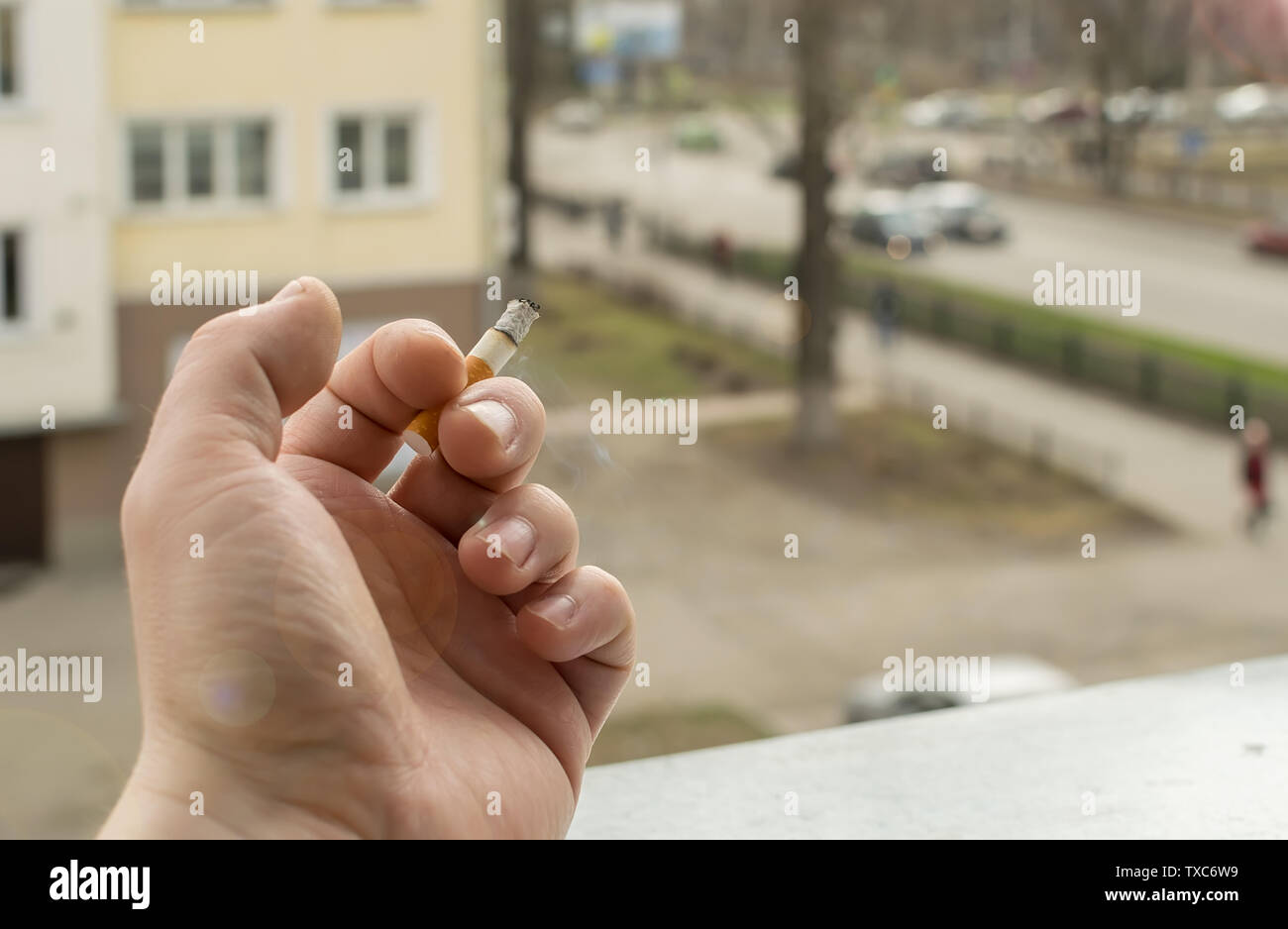 View of the hand of a Smoking man with a Smoking cigarette from the ...