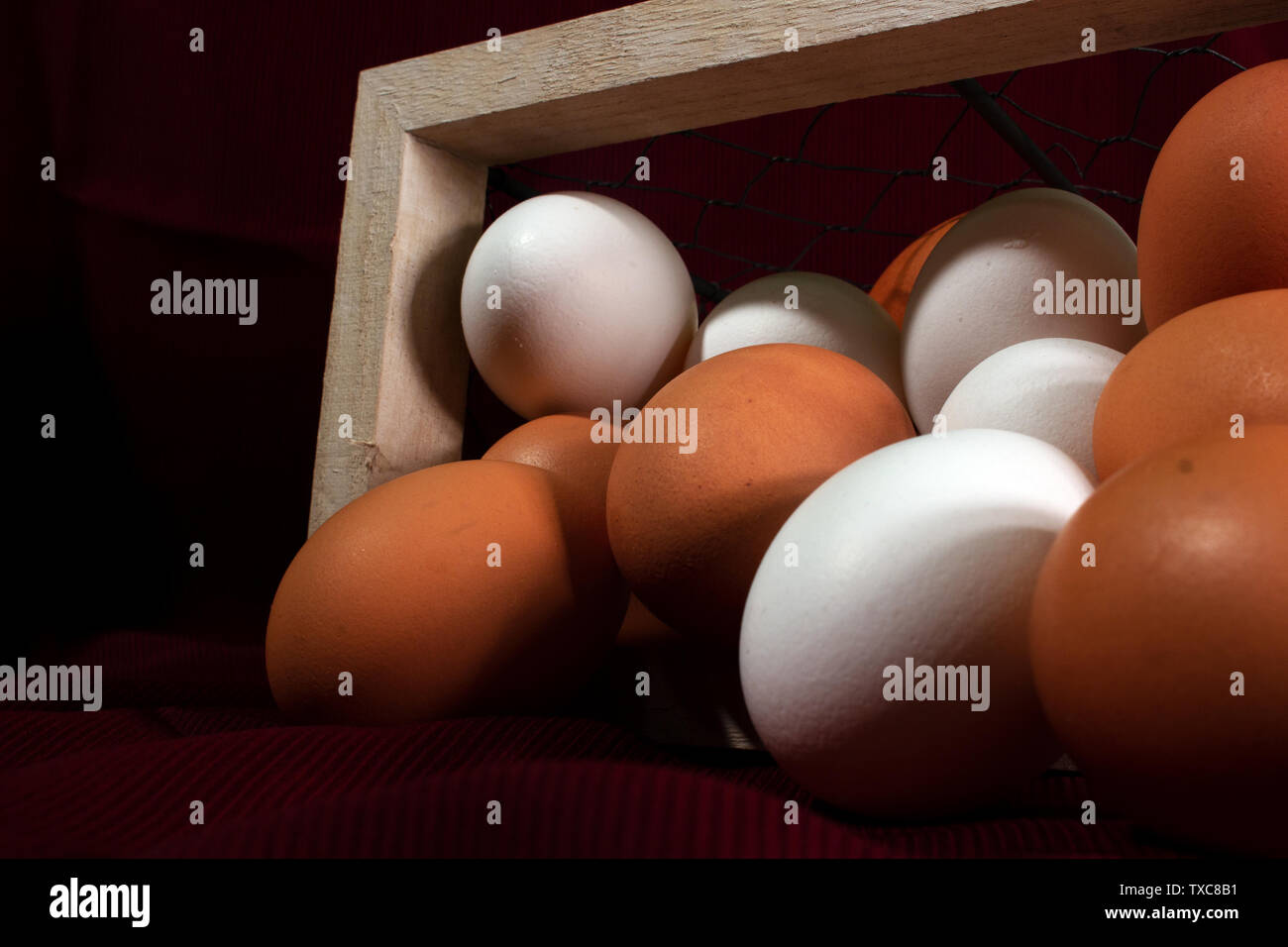 Different kinds of eggs falling out of a basket Stock Photo - Alamy