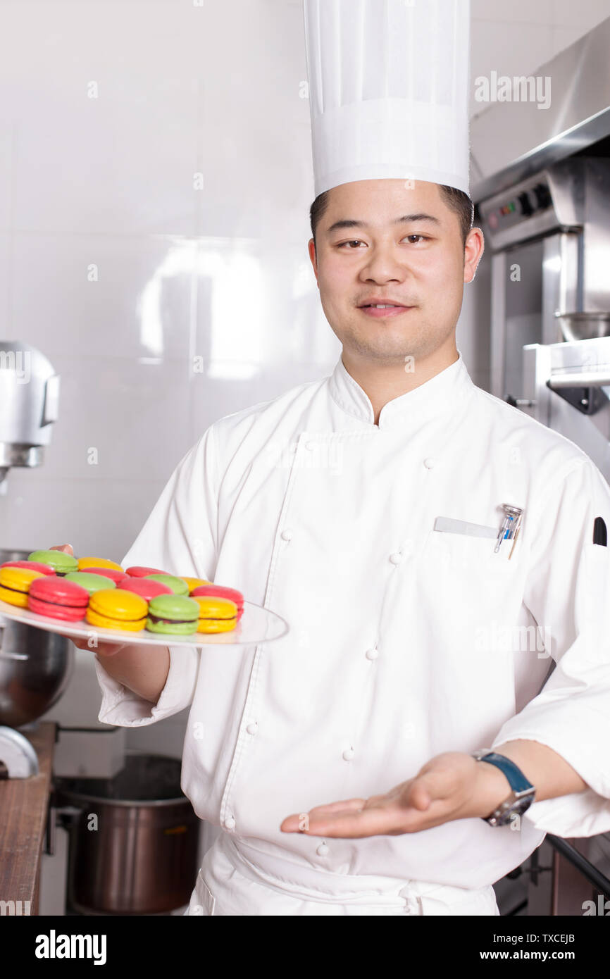 young chinese man chelf making food in modern kitchen Stock Photo - Alamy