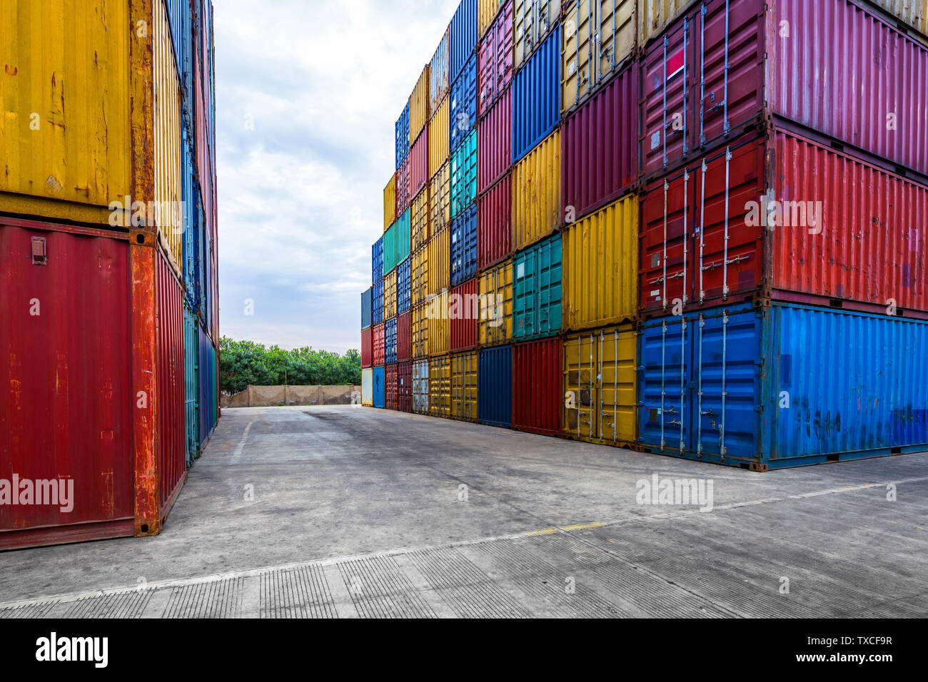 stack of containers with empty road in front Stock Photo - Alamy