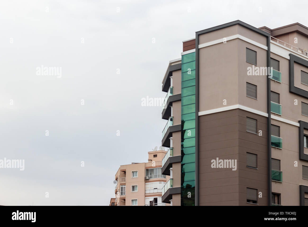 a corner shoot from a tall modern building with brown and cream colors ...