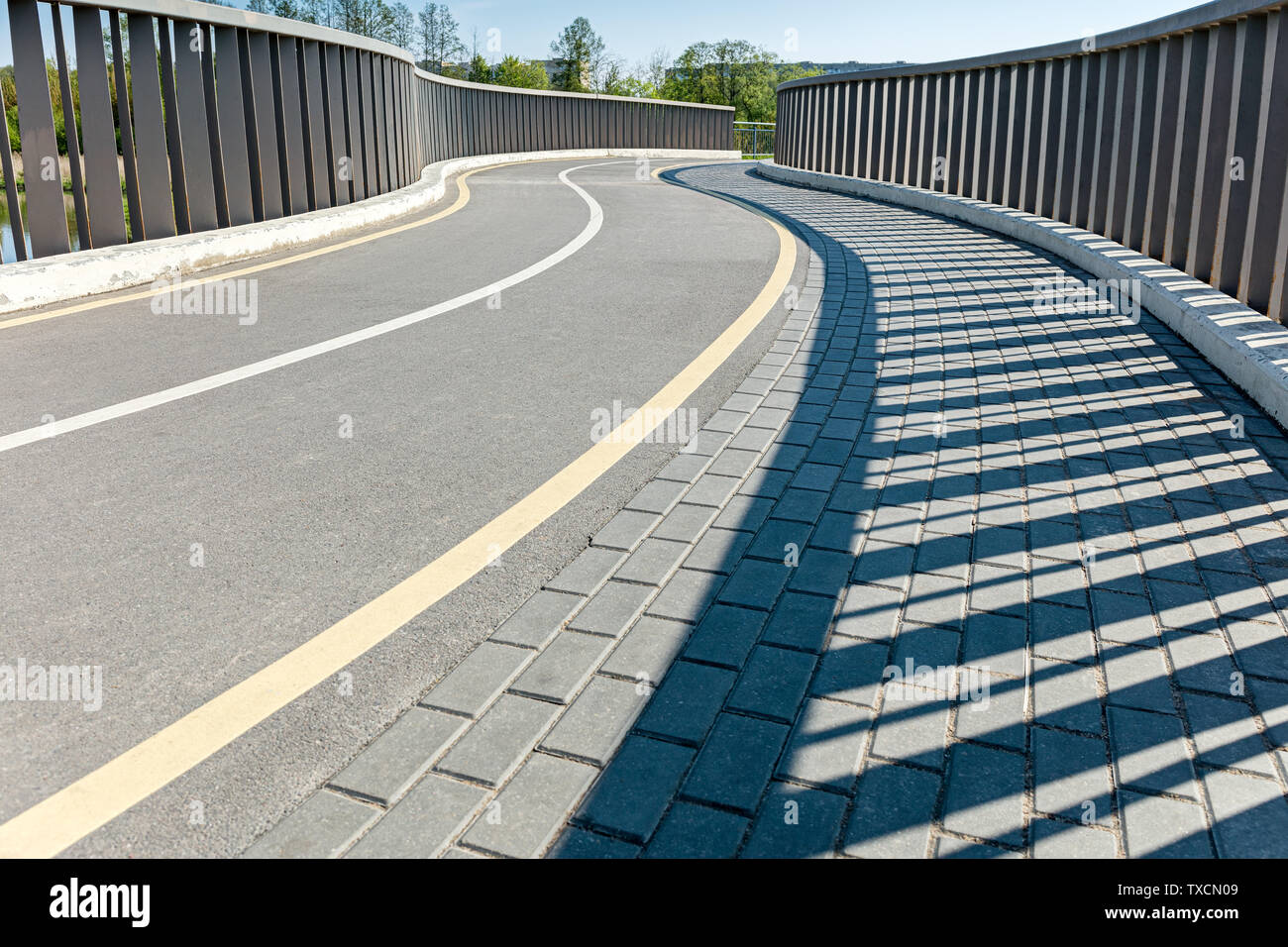 empty bike lane on bridge with road marking on asphalt Stock Photo - Alamy