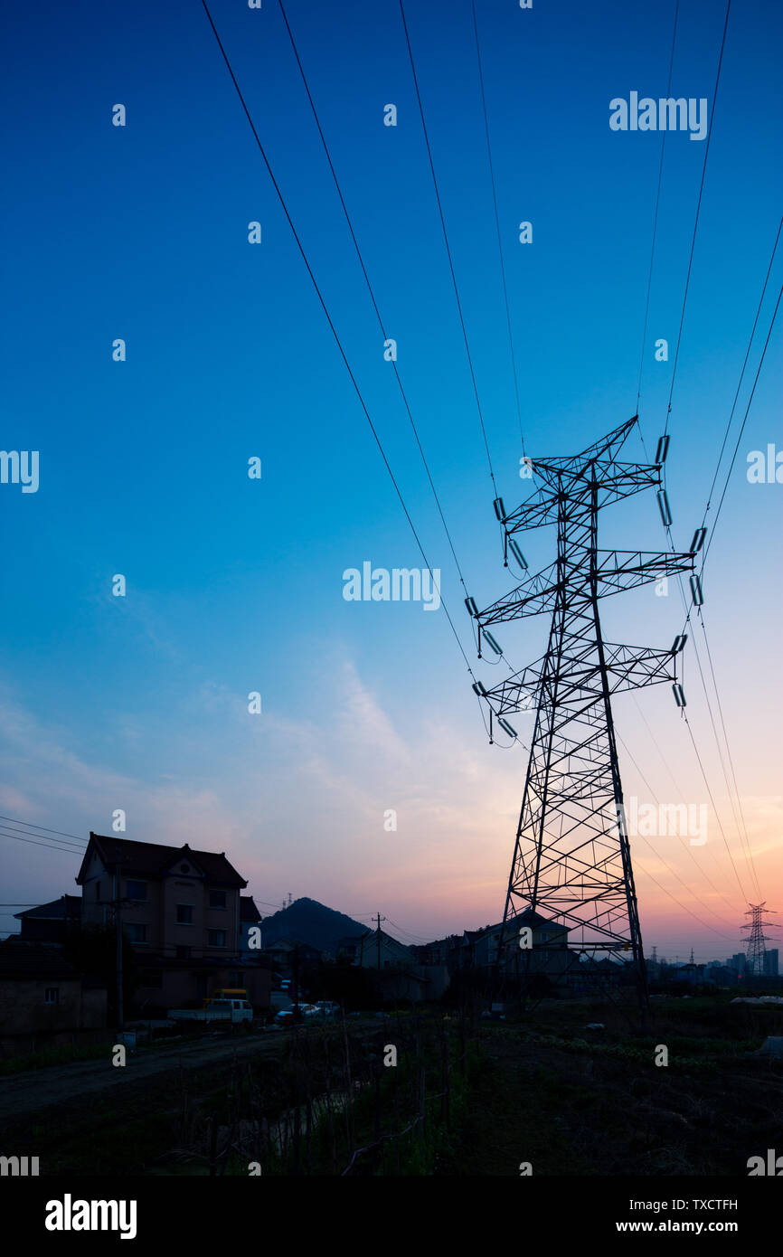 Pylons in blue sky at sunrise Stock Photo - Alamy