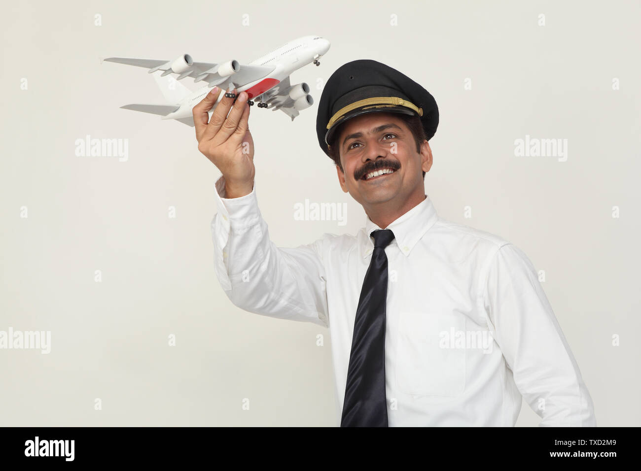 Pilot holding model airplane Stock Photo - Alamy