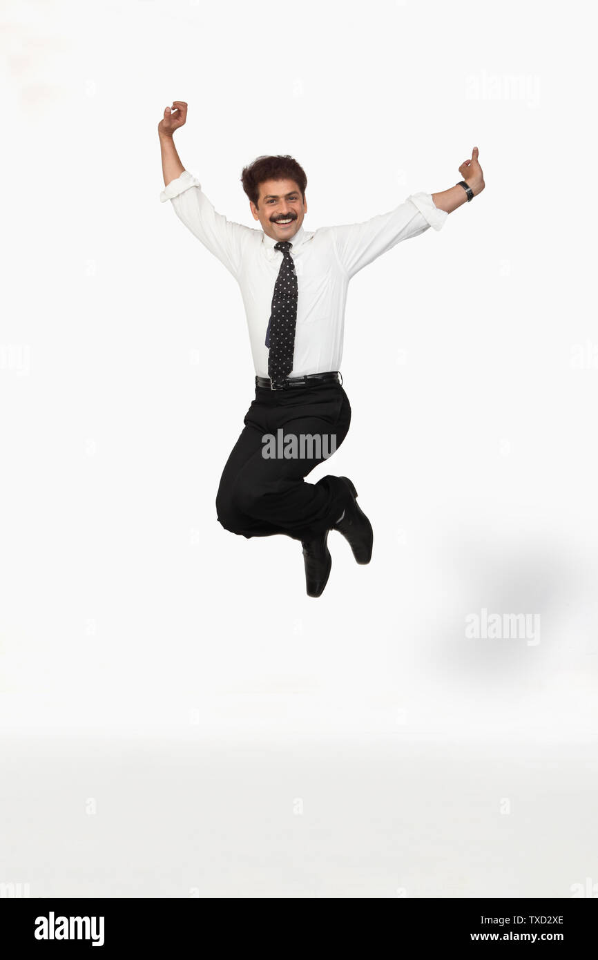 Businessman jumping in air Stock Photo - Alamy