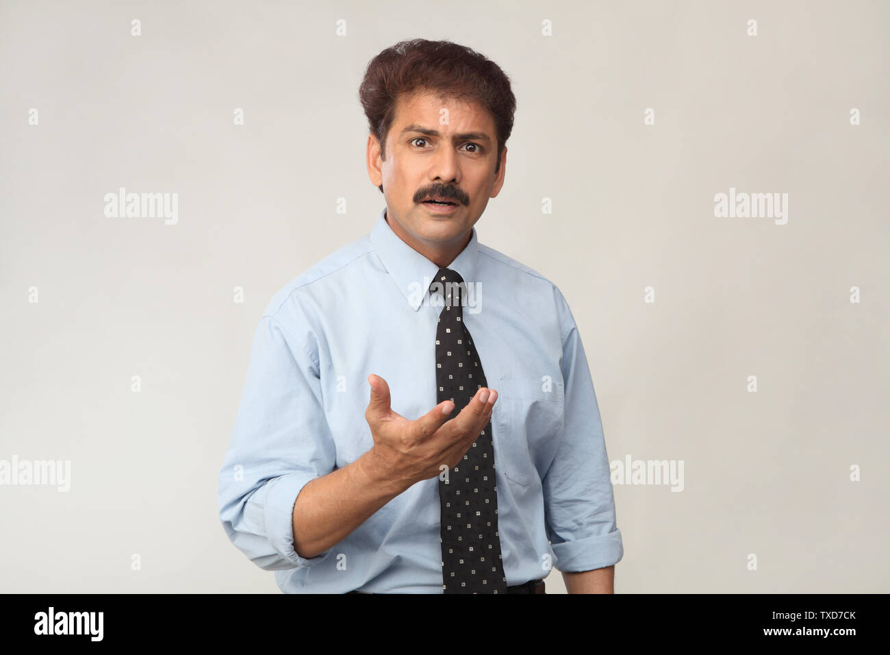 Portrait of a businessman with unhappy questioning look Stock Photo - Alamy