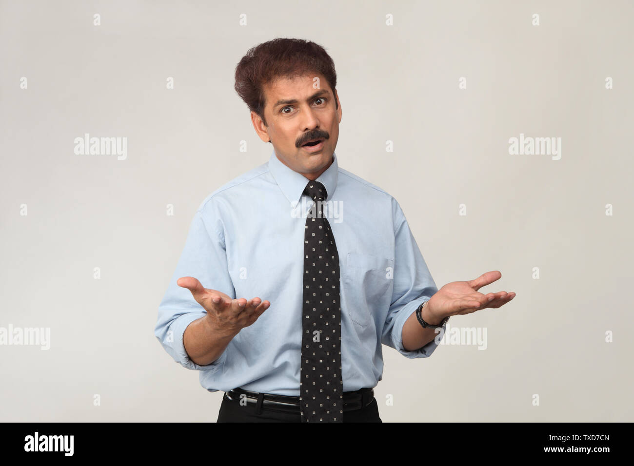 Portrait of a businessman with unhappy questioning look Stock Photo - Alamy