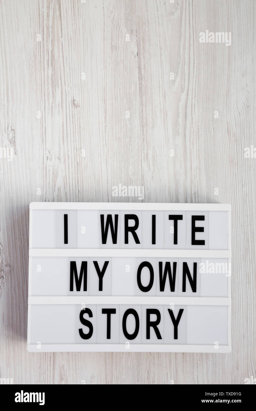 Modern board with 'I write my own story' words on a white wooden ...
