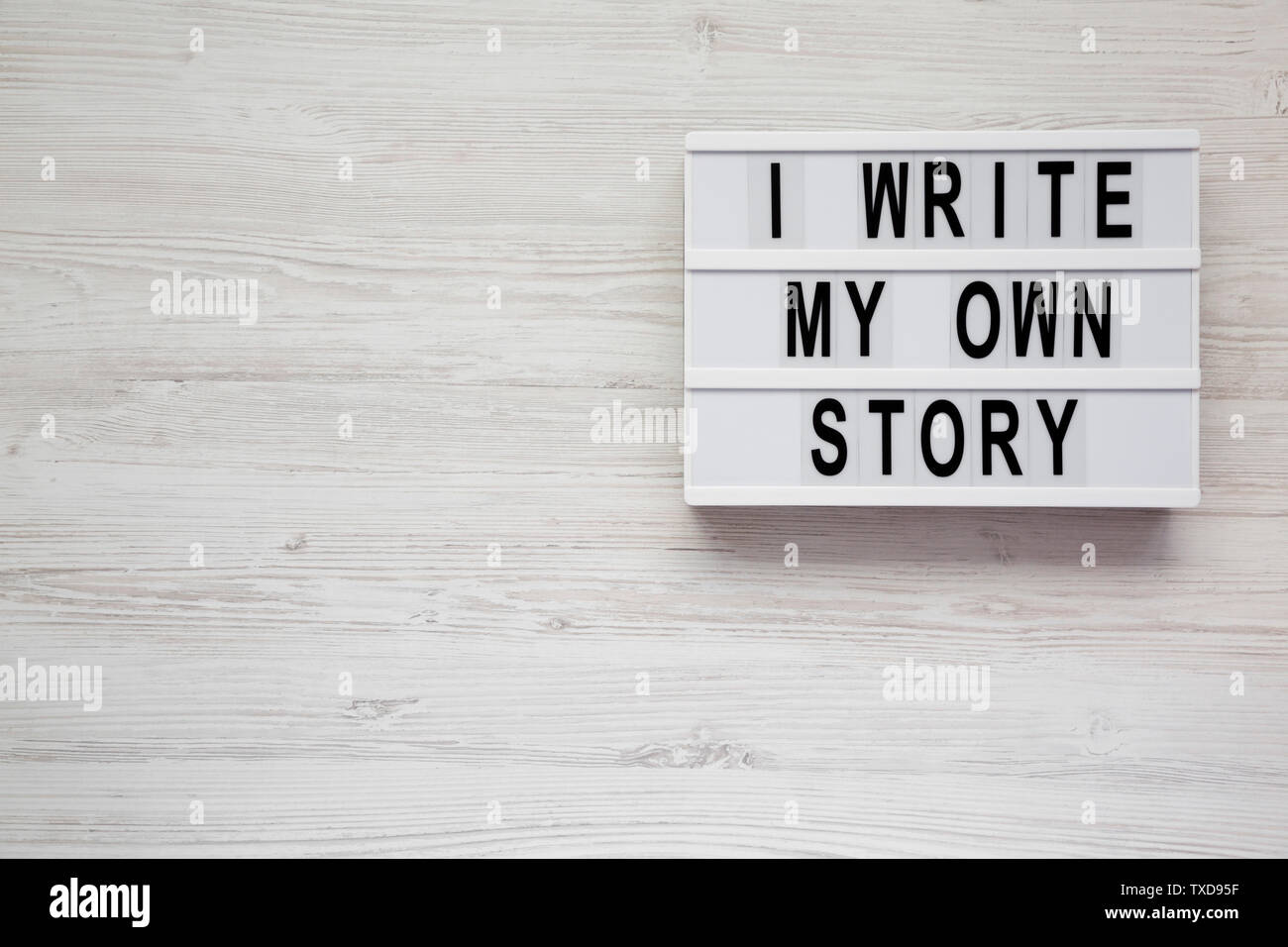 'I write my own story' words on a modern board on a white wooden ...