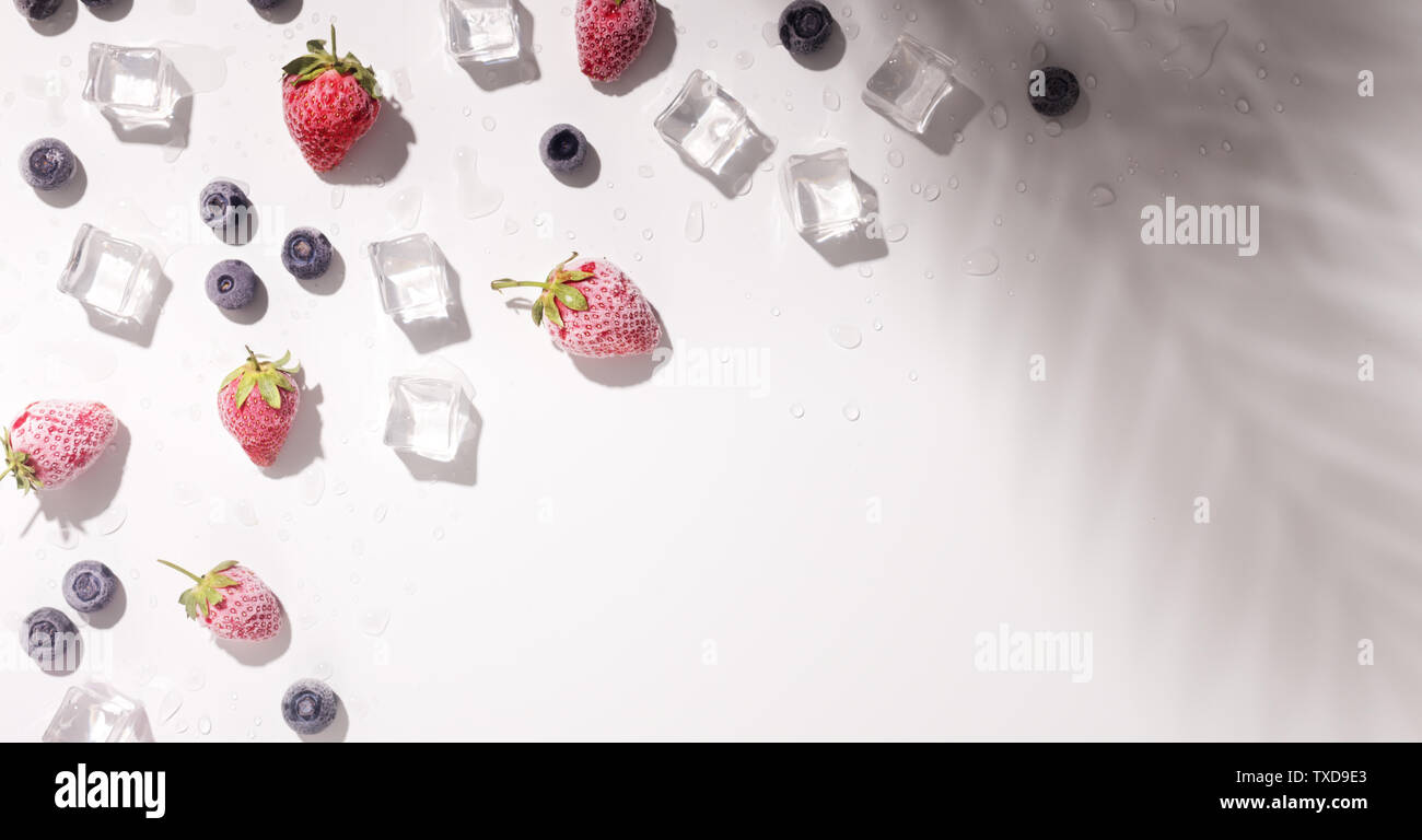 Summer time. Frozen fruits for fresh cocktails with ice cubes on white ...