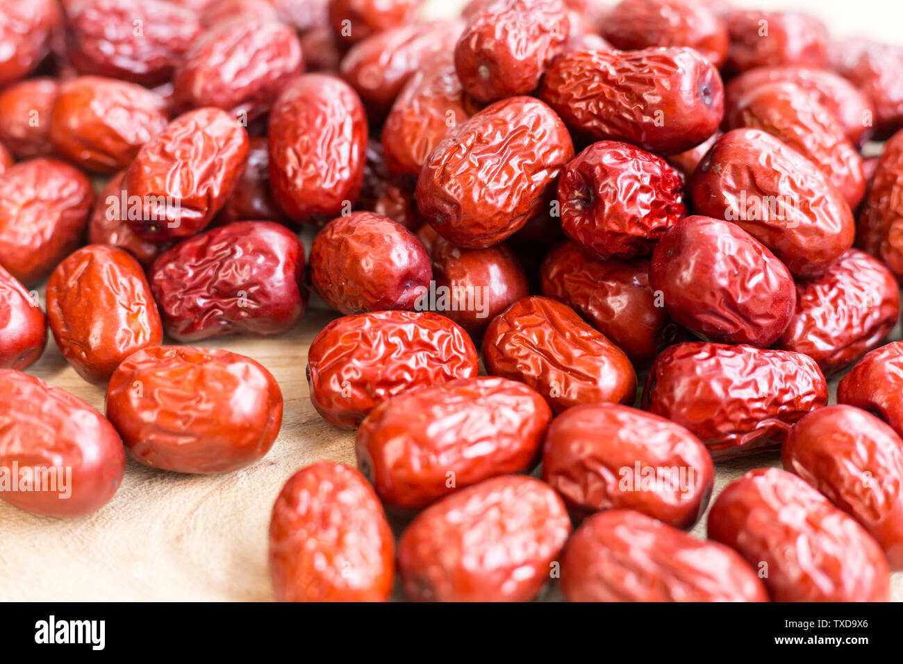 Red dates all over the table Stock Photo - Alamy