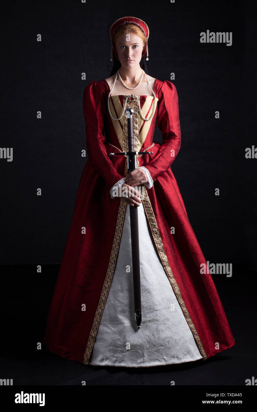 Tudor woman in red dress on black background Stock Photo - Alamy