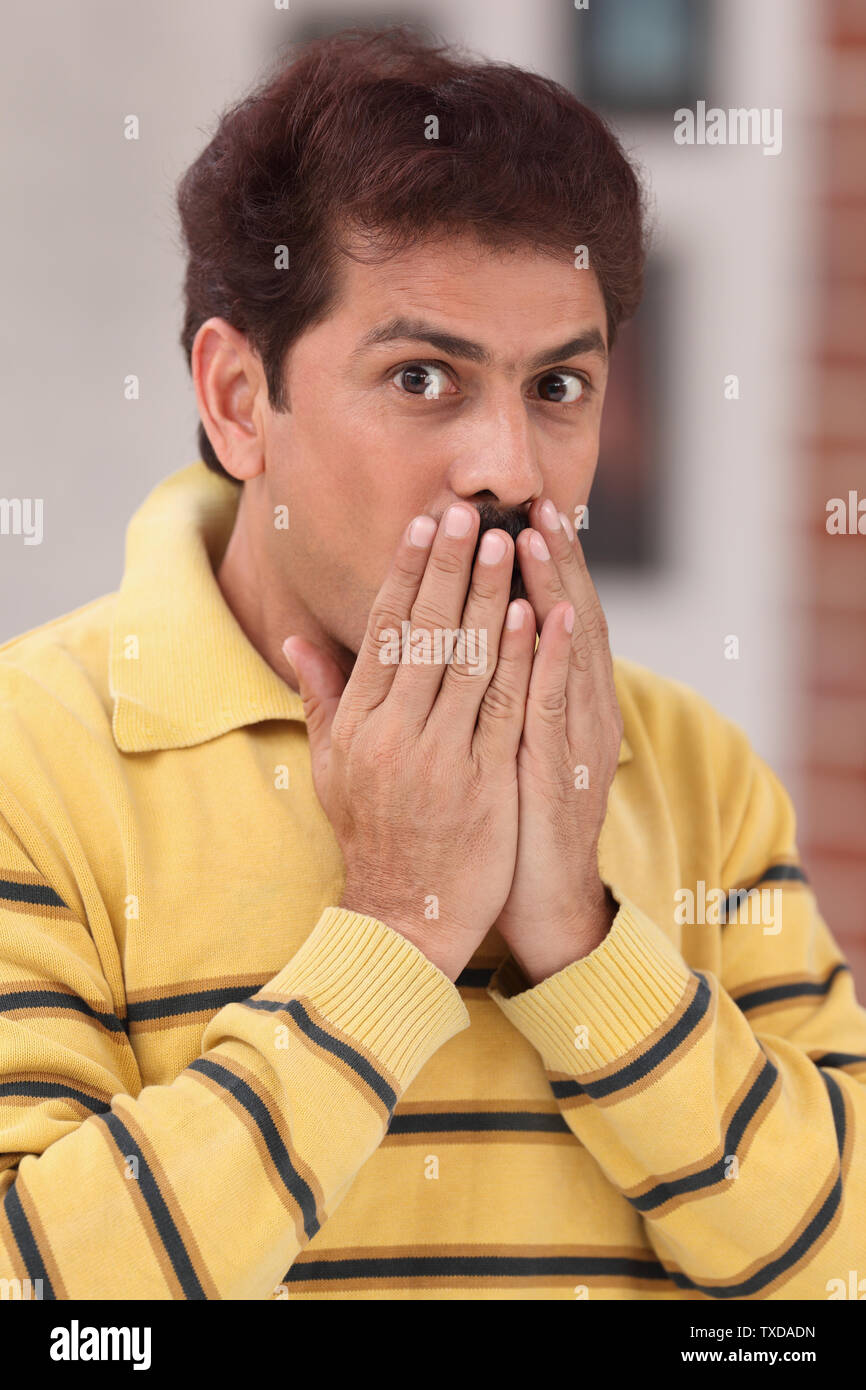 Portrait of a man looking shocked Stock Photo - Alamy