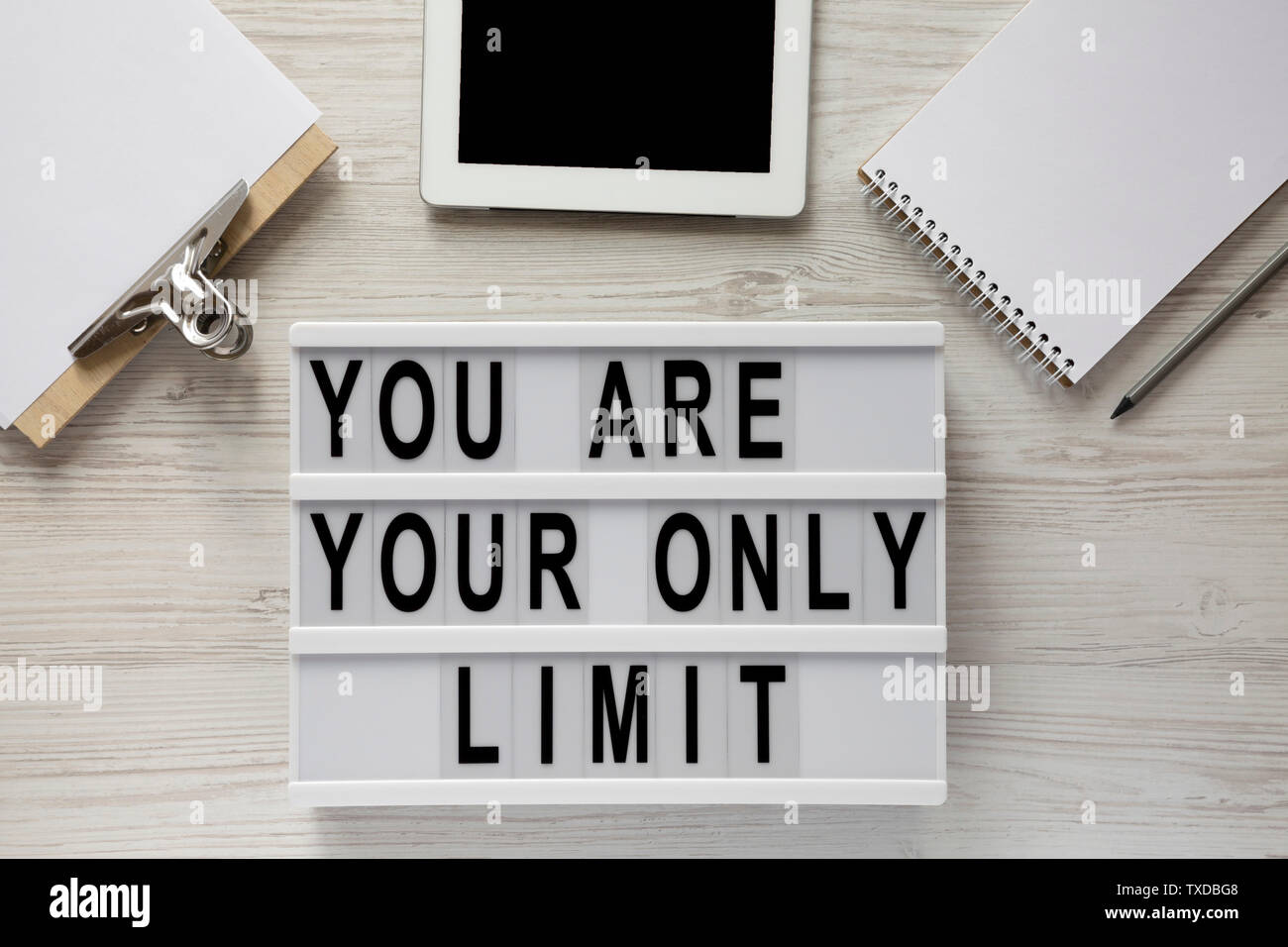 'You are your only limit' words on a modern board, clipboard with blank ...