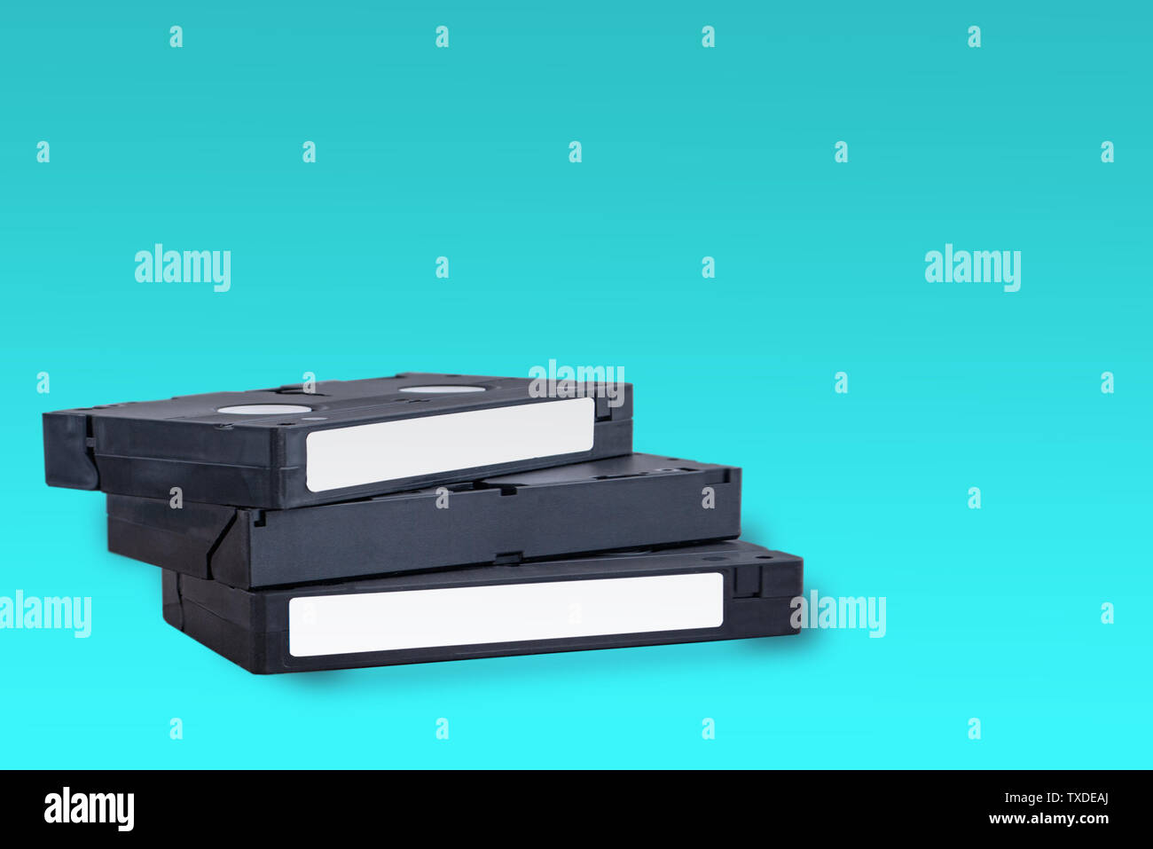 VHS videotapes on a blue background stacked vertically on each other ...
