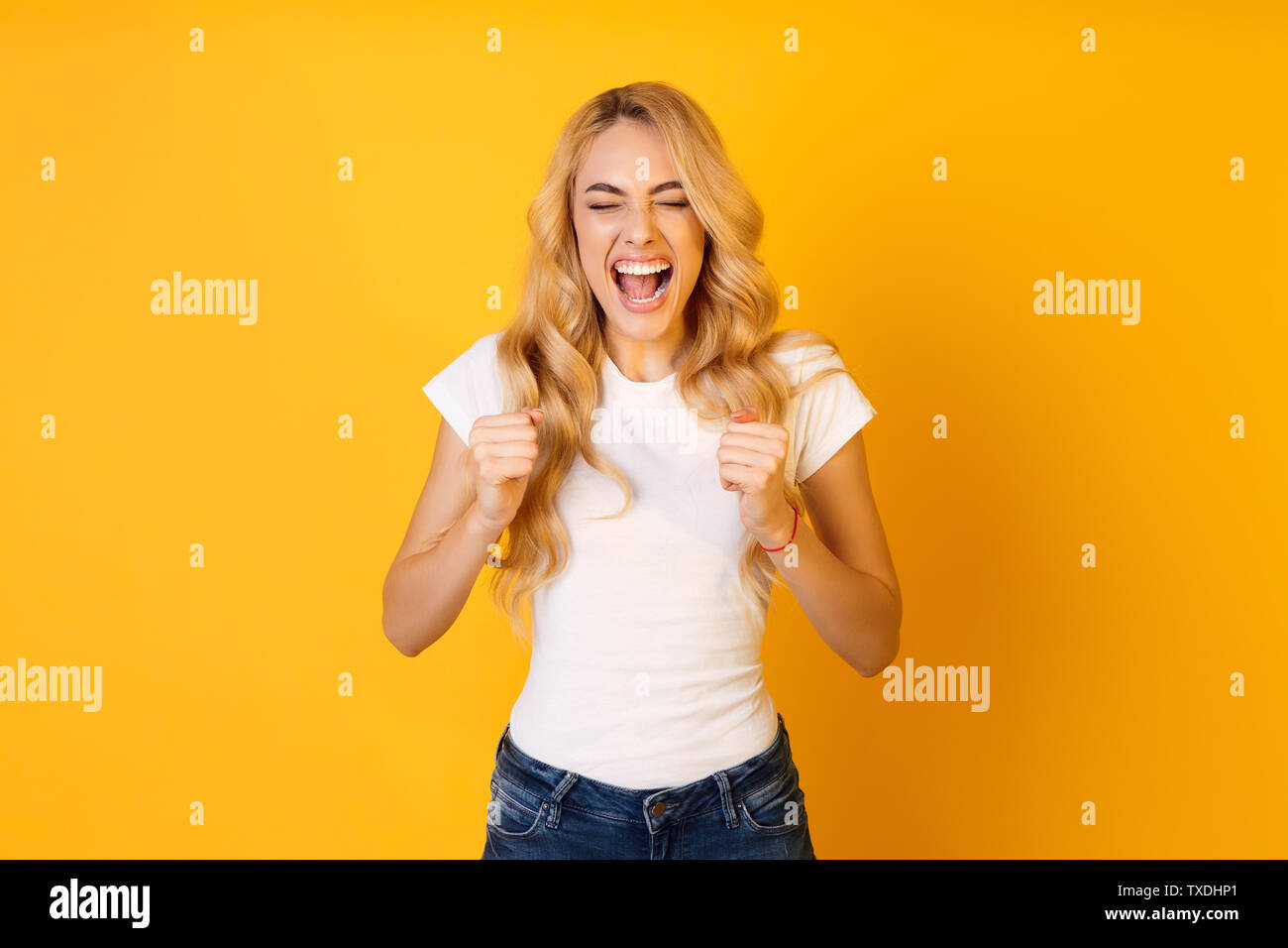 Excited Lady Screaming And Making Winner Gesture Over Yellow Background ...