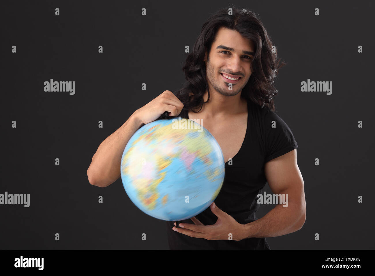 Portrait of a man holding a globe Stock Photo - Alamy