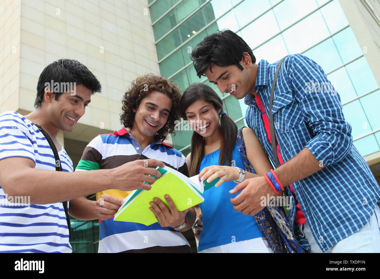 College students reading a book at the campus Stock Photo - Alamy