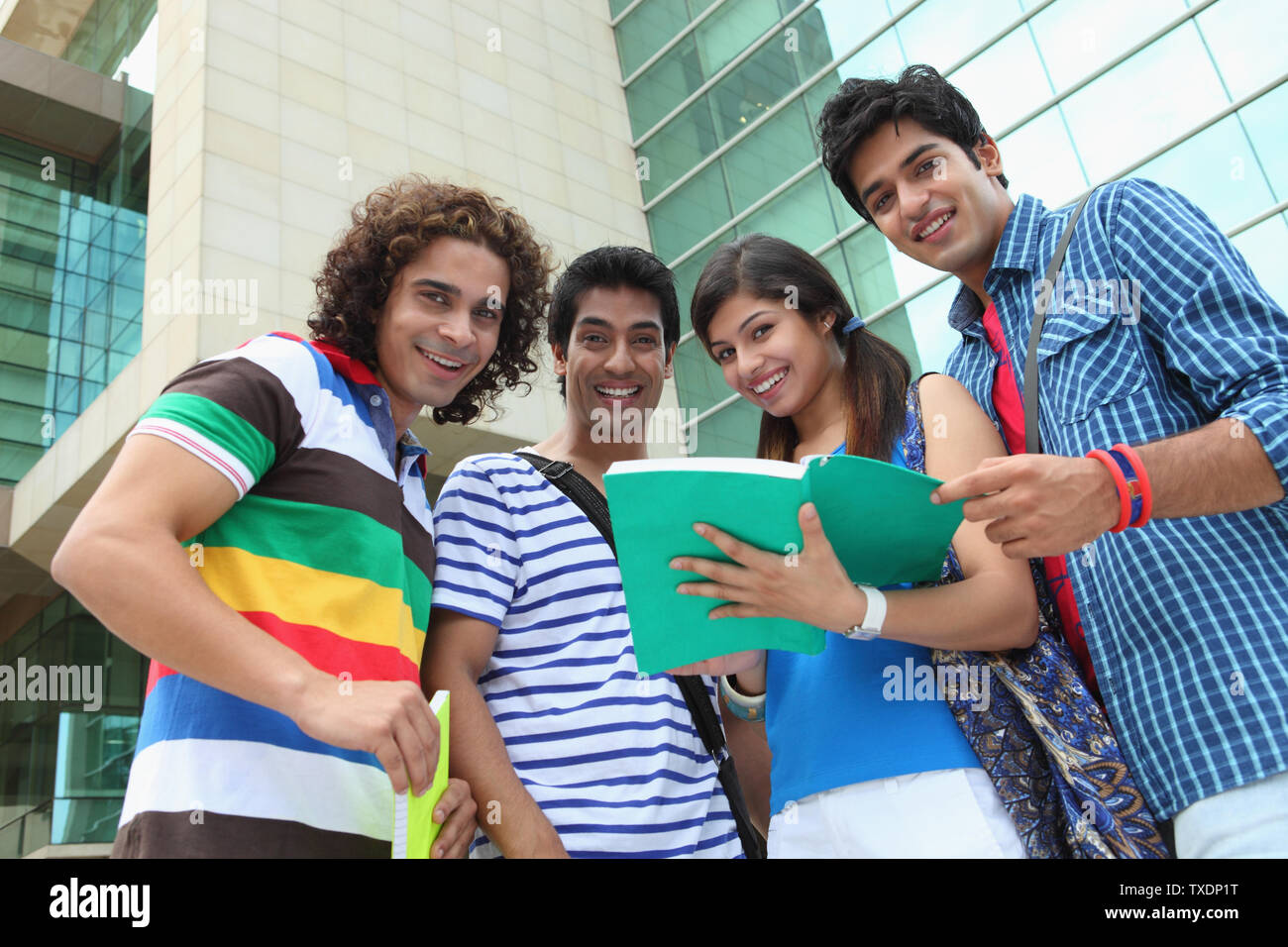 College students reading a book at the campus Stock Photo - Alamy