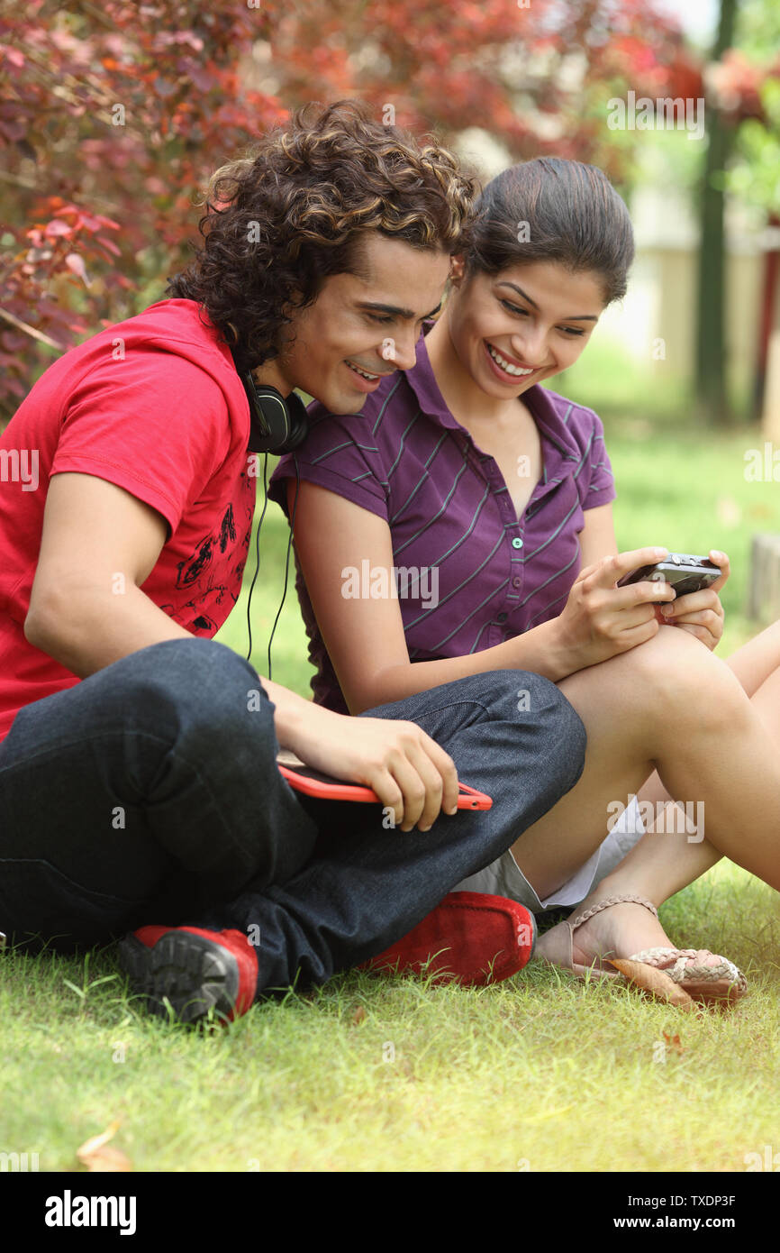 College students looking at video playback in digital camera Stock ...