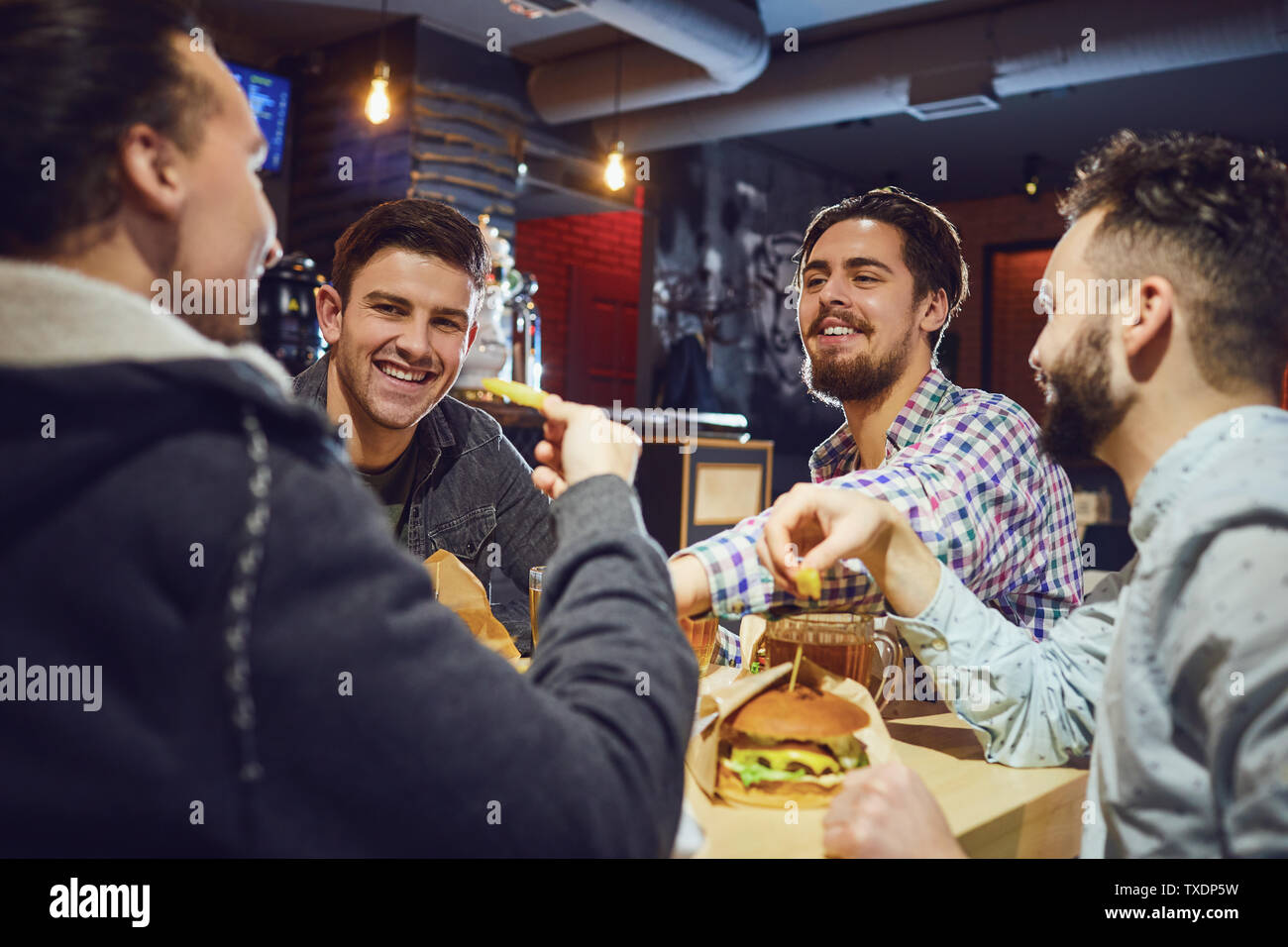 Happy friends restaurant dinner beer hi-res stock photography and ...