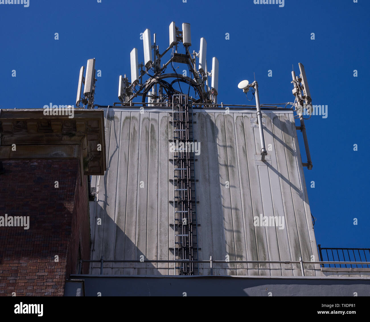 communications aerials on a roof top with blue sky Stock Photo - Alamy