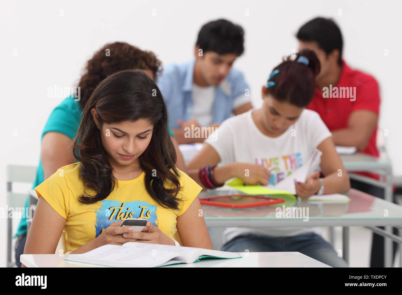 Teenager texting classroom hi-res stock photography and images - Alamy