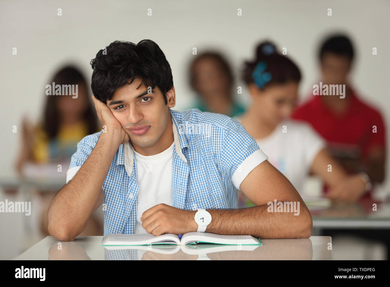 Portrait of a male college student in a classroom looking bore Stock ...