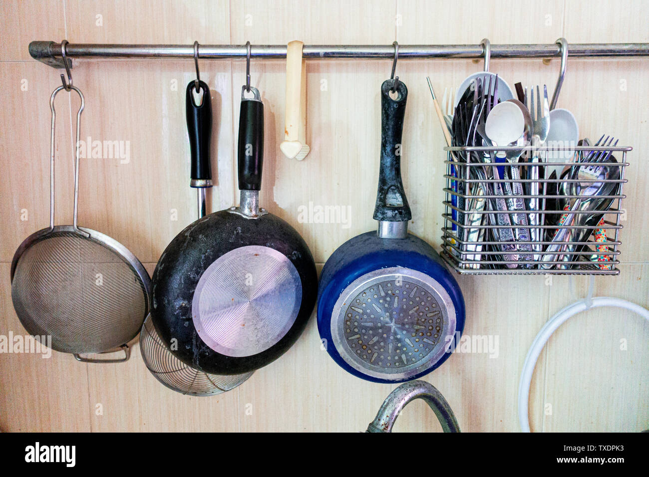Cooking utensils including colander, frying pan, pot and some ...