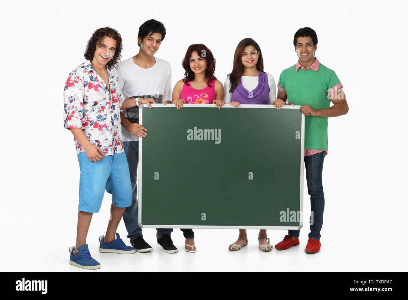 Group of friends holding a placard and smiling Stock Photo - Alamy