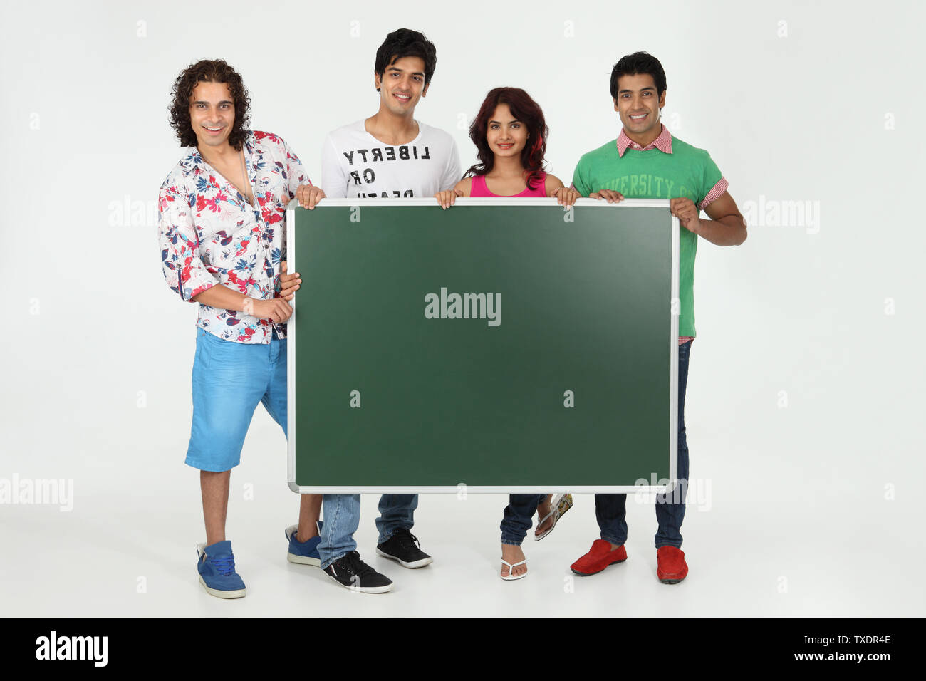 Group of friends holding a placard and smiling Stock Photo - Alamy
