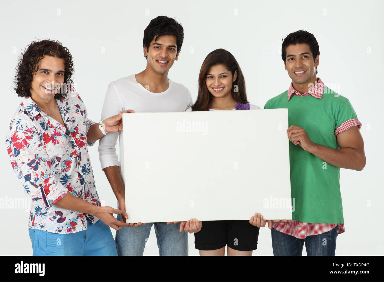Group of friends holding a placard and smiling Stock Photo - Alamy