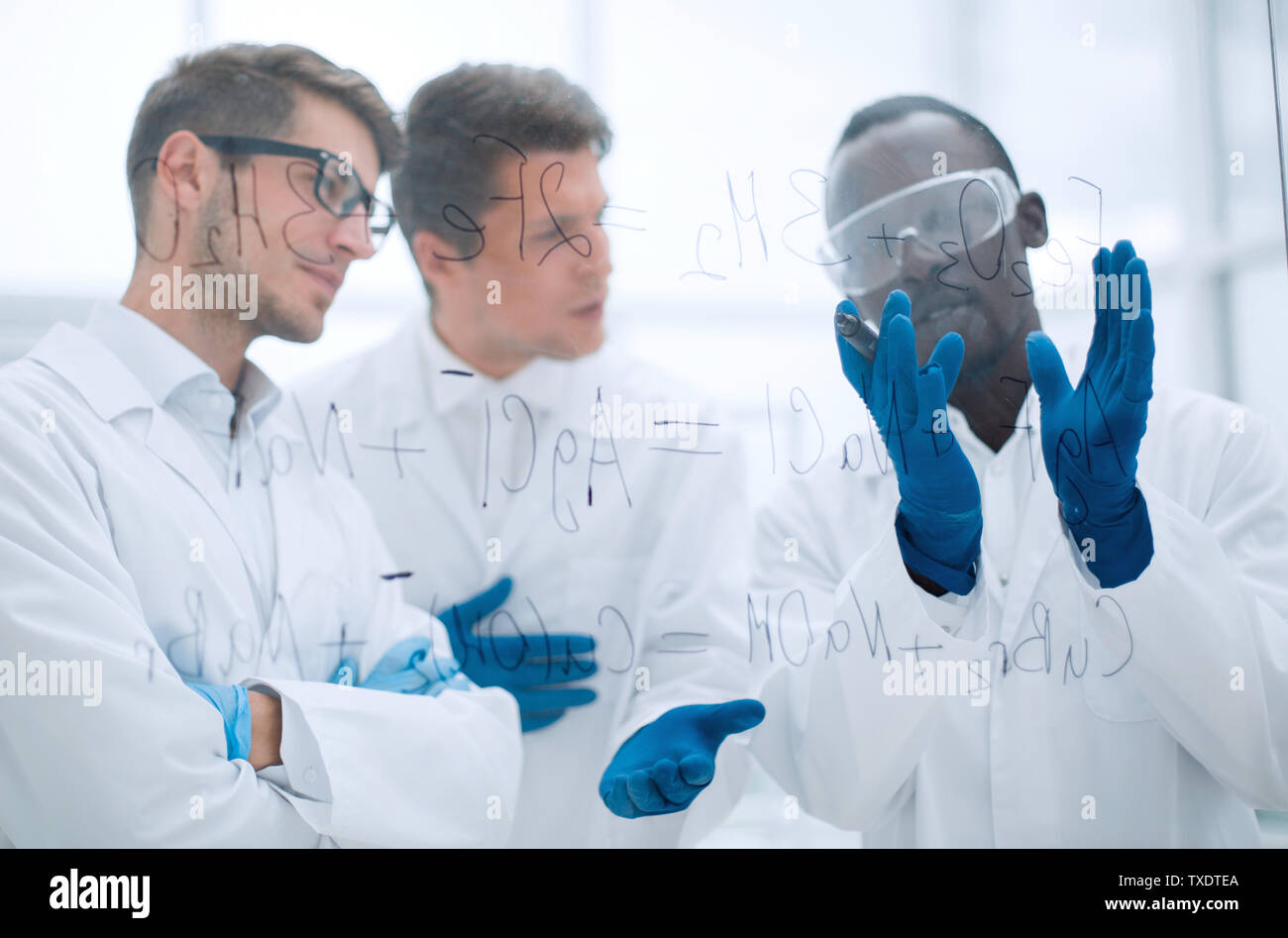 group of scientists talking standing near a glass Board Stock Photo - Alamy