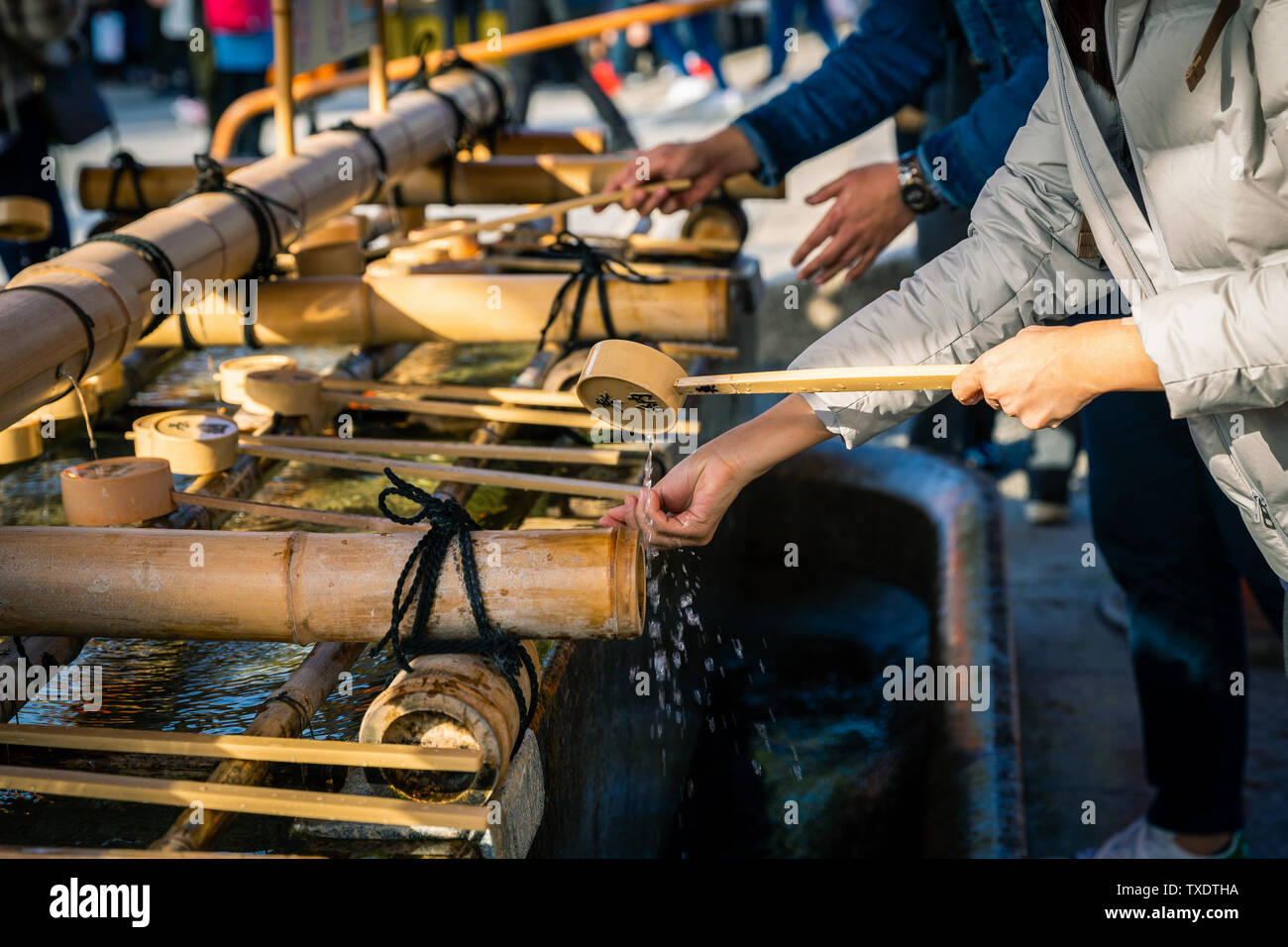 Kyoto, Japan - November 21, 2018: Tourist pouring holy water by water ...