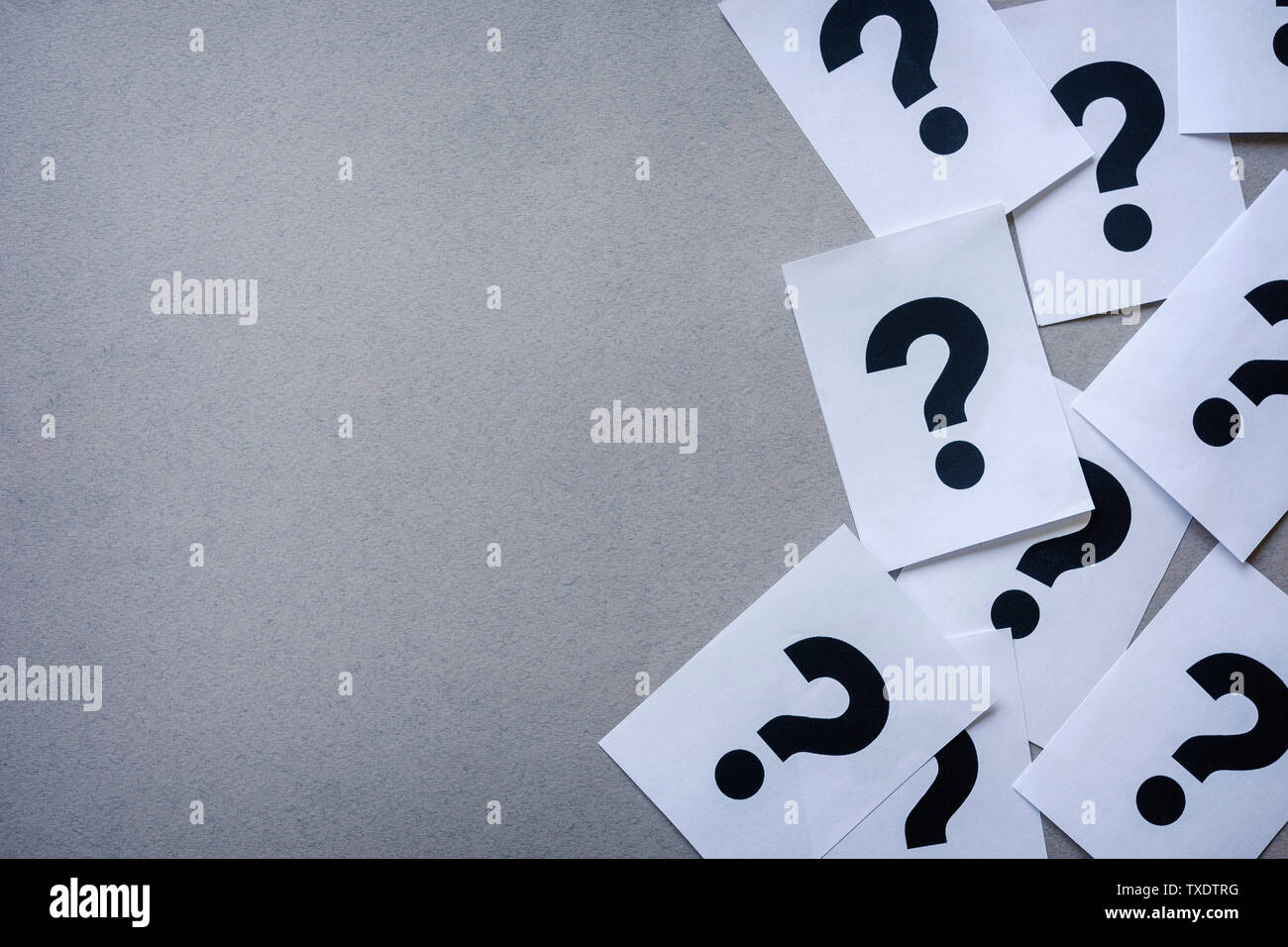 Side border of printer question marks on white paper in a random ...