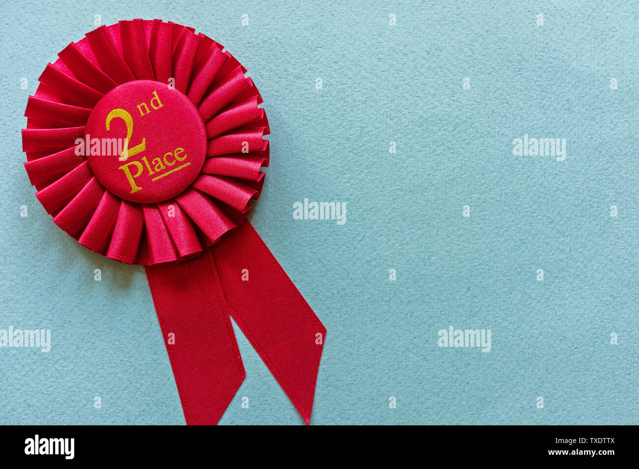 Red 2nd Place Winners rosette on light blue background with lateral ...