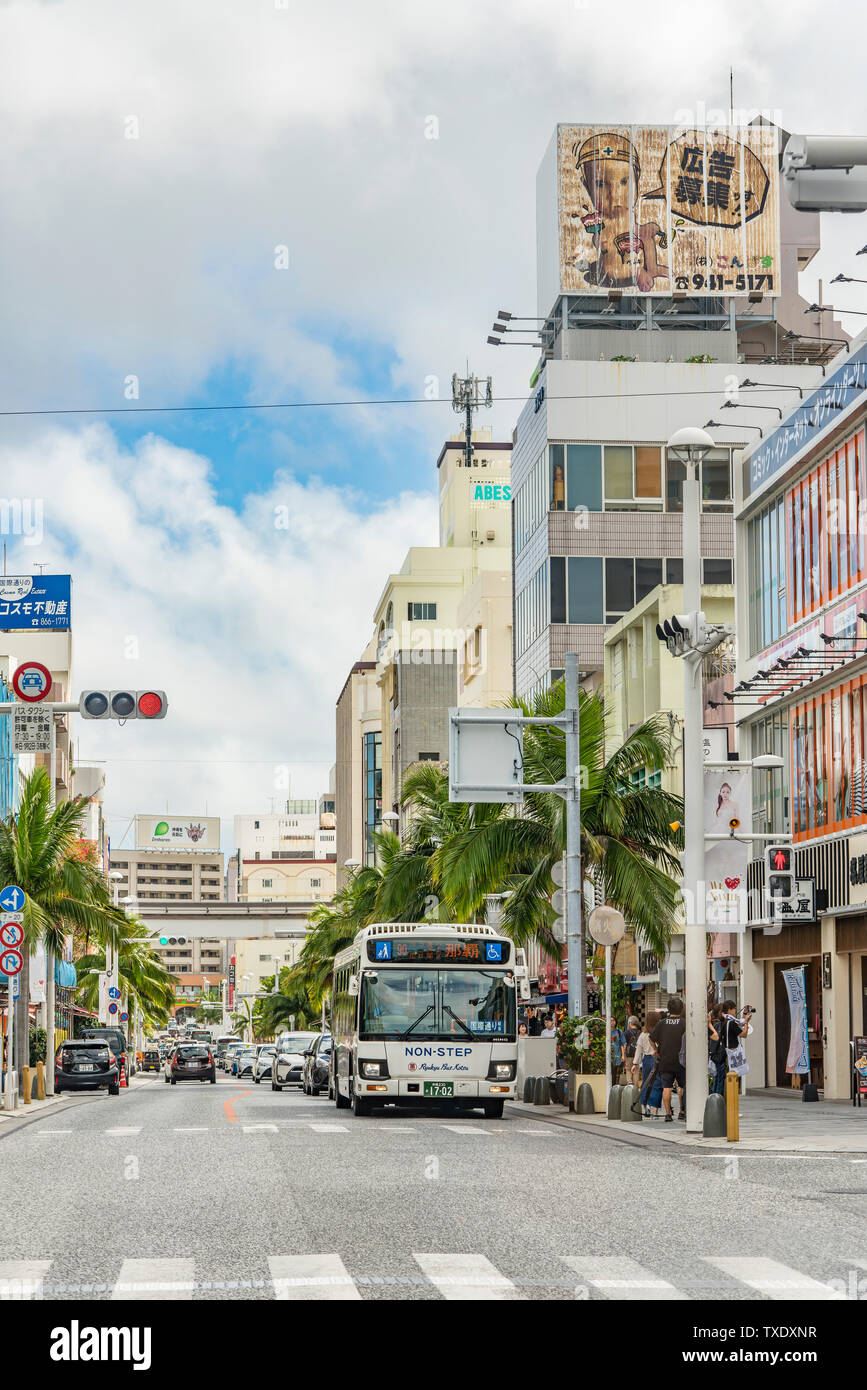 Naha city non-step bus running through palm tree lined streets under ...