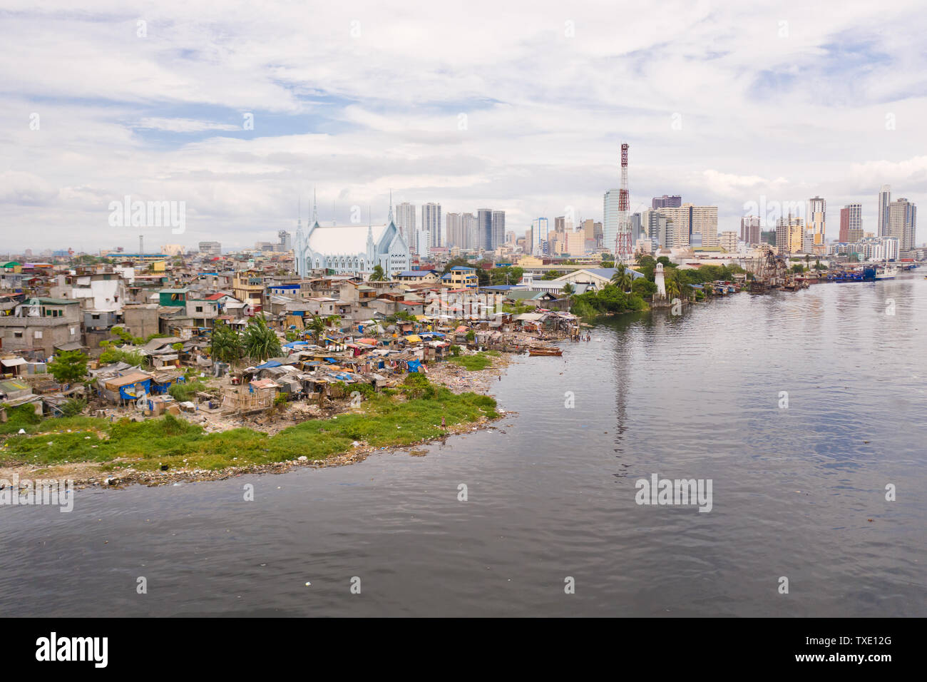 Slums of poor people on the background of a big city. The city of ...