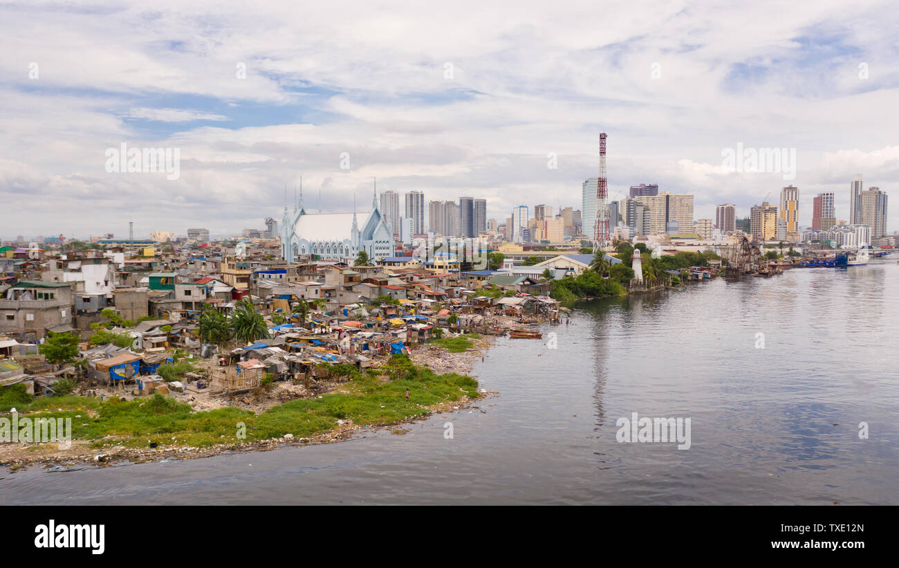 Slums of poor people on the background of a big city. The city of ...