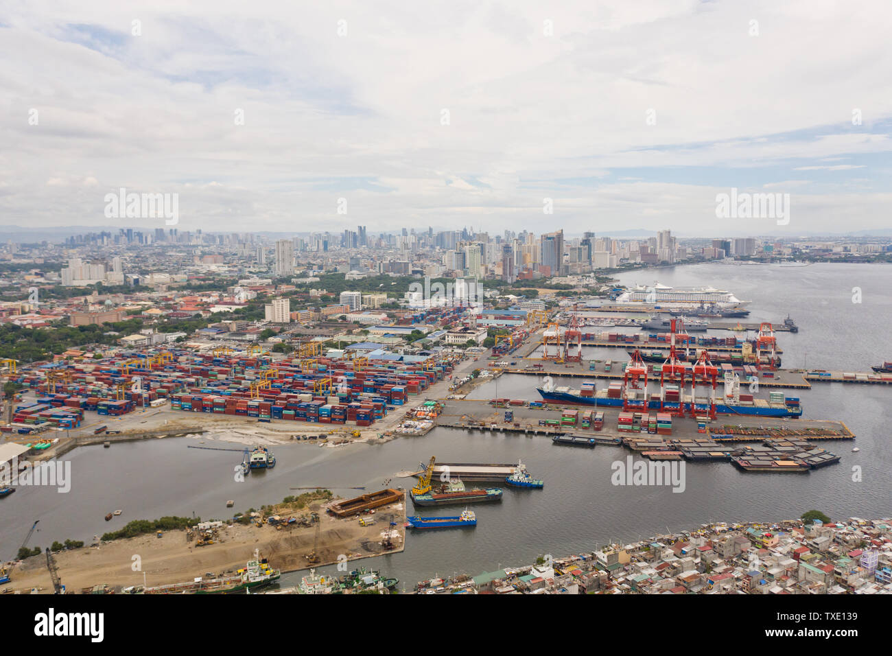Trading port in Manila. Cargo cranes and containers in the port ...