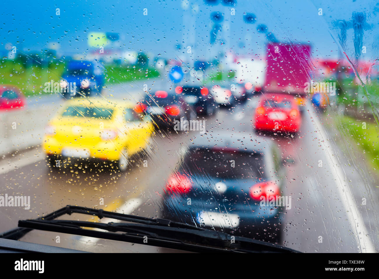 raining on the window of car. cars on the road, transportation concept ...