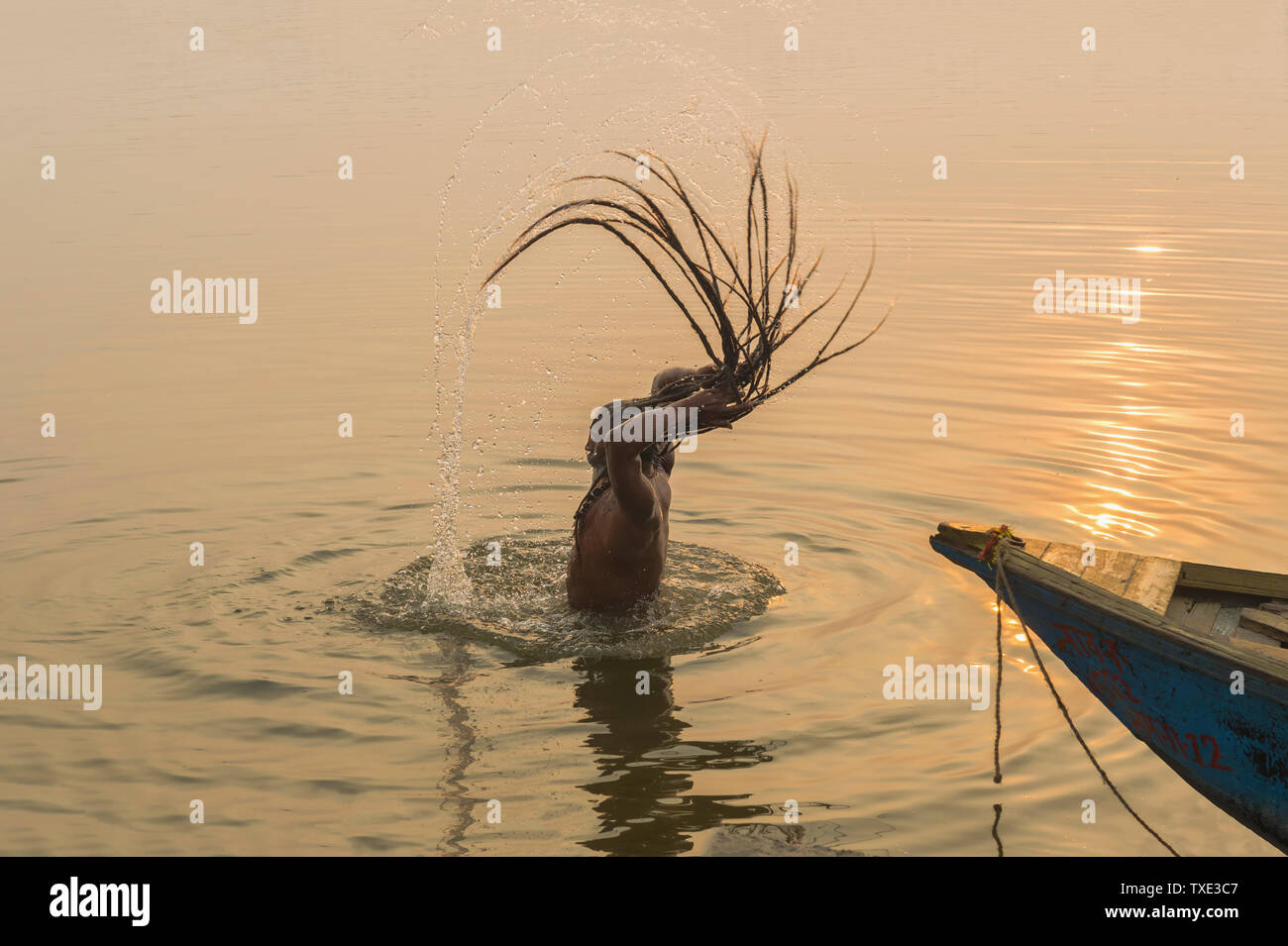 Rome baba with water spraying from his flying dreadlocks in the Ganges ...