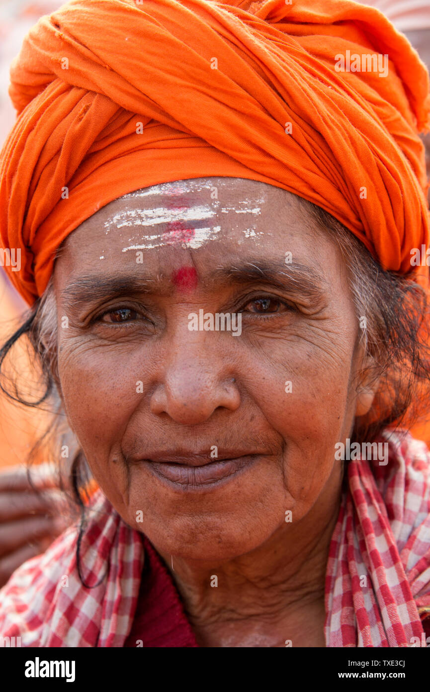 Portrait of a Sadhvi in orange red saree during Allahabad Kumbh Mela ...