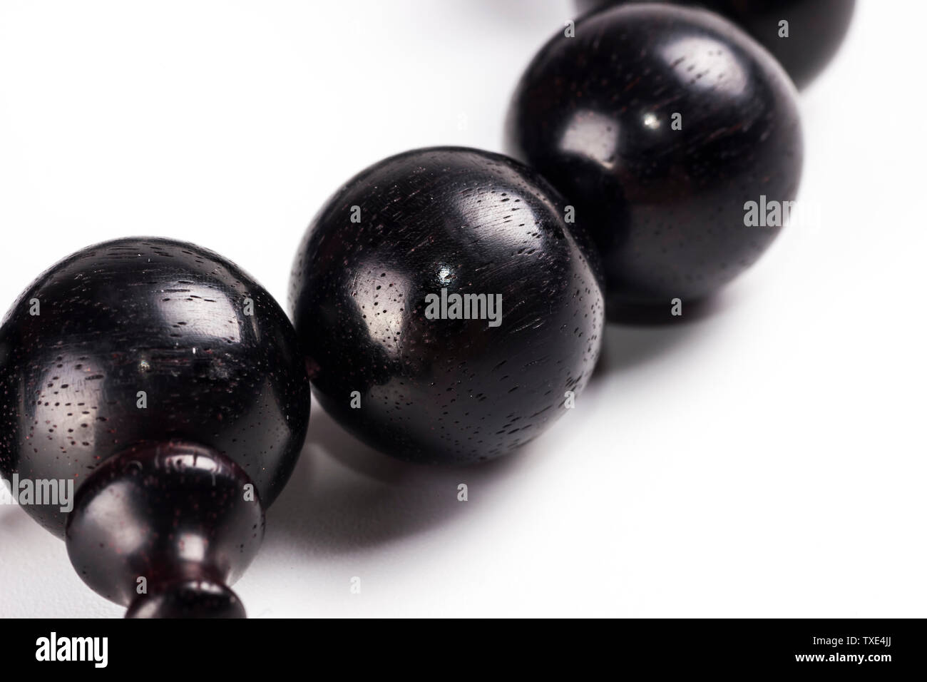 Hand string leaflet rosewood beads Stock Photo - Alamy